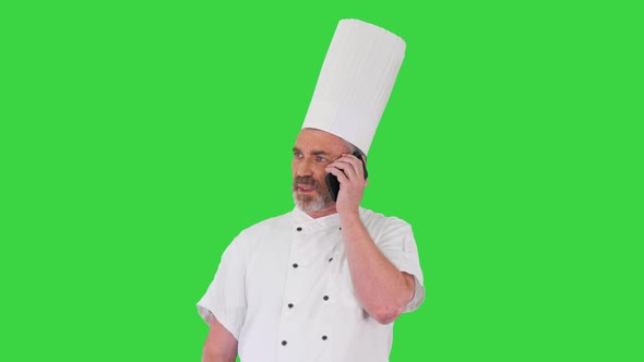 Concentrated Male Cook Making a Call on a Green Screen Chroma Key ...