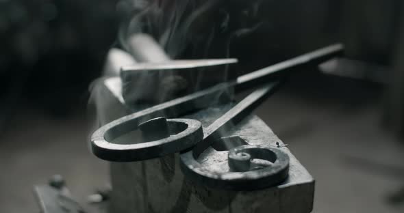 Smoking Forged Metal Rods Lie on the Anvil Next to the Hammer Quench ...