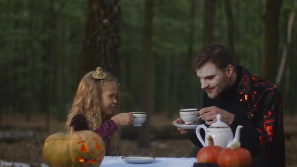 Cute Charming Girl Clinking Tea Cups with Man in Vampire Costume ...