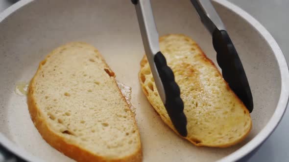 Anonymous person frying bread slices in pan, Stock Footage | VideoHive