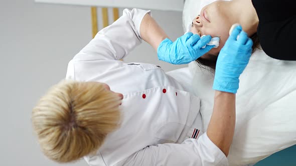 Beutician Doctor Wiping Patient's Face with Cotton Pads, Stock Footage