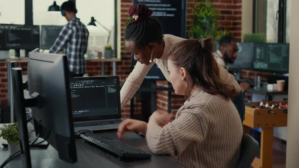 Two Software Coders Analyzing Source Code Looking For Errors Running On Laptop Screen Stock Footage