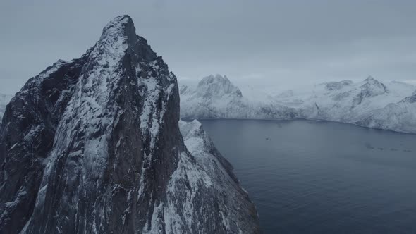 Aerial drone view passing the rocky Segla peak, winter, polar night in ...