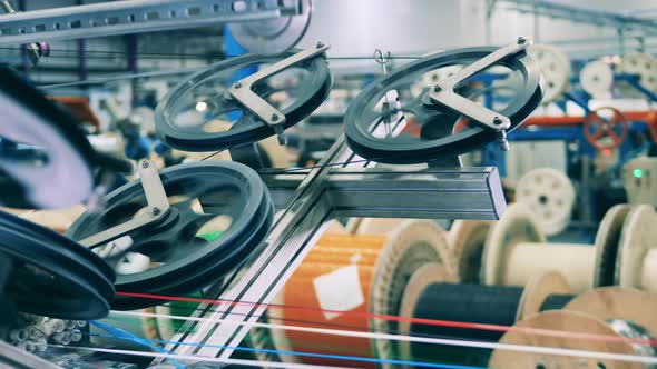 Several Spinning Shafts with Electrical Cables at a Factory, Stock Footage