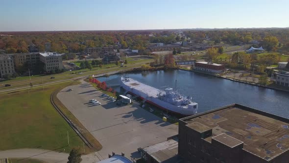 Rotating aerial shot of old tank landing ship USS LST 393 in Muskegon ...