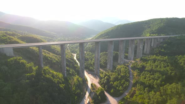 Aerial Shot of Viaduct Highway Bridge Above Deep Valley at Sunset in ...
