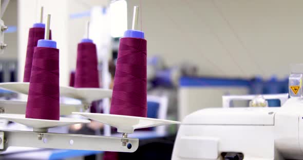 Purple spool of sewing threads unrolling on sewing machine, Stock Footage