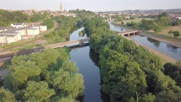 Aerial, railway crossing River Exe with cityscape background in Exeter ...