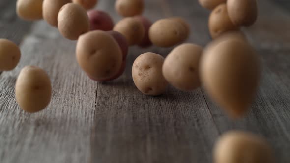 Potatoes falling and rolling on a table. Slow Motion., Stock Footage