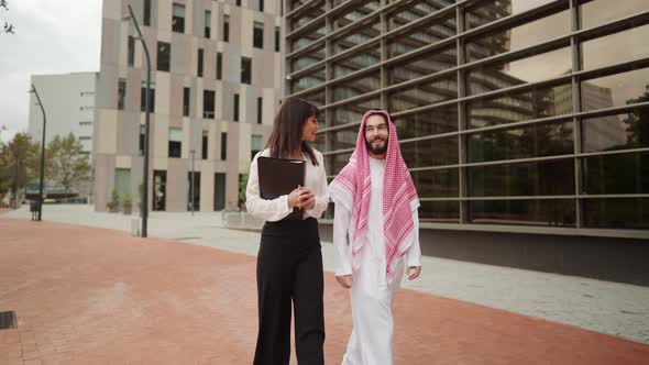 Arab Businessman and European Businesswoman Talking Pleasantly and ...