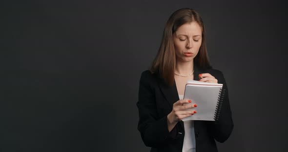 Vexed and Angry Woman in Black Suit Crosses Out Hes Notes in the ...