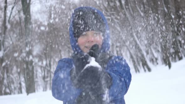 Portrait Of A Young Guy Clapping Hand With Snow In The Winter Forest ...