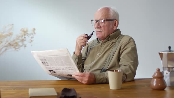 Elderly Man Smoking Pipe and Reading Newspaper, Stock Footage | VideoHive