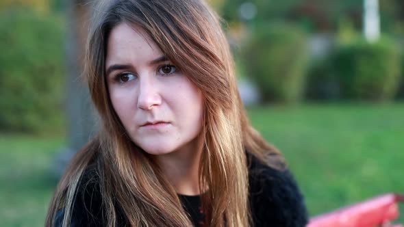 Sad woman, upset girl in park, girl looking away while avoiding gaze ...