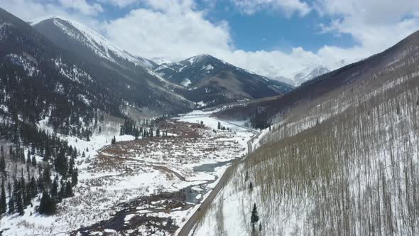 Road in between two mountain ranges in winter season during snowfall ...