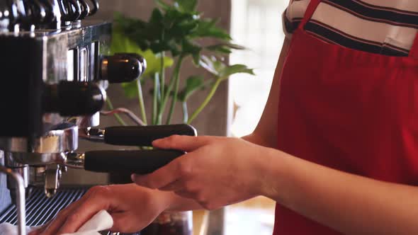 Waitress wiping espresso machine with napkin in caf , Stock Footage