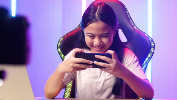 Excited Asian Kid Girl Playing Video Game With Mobile Phone While Live ...