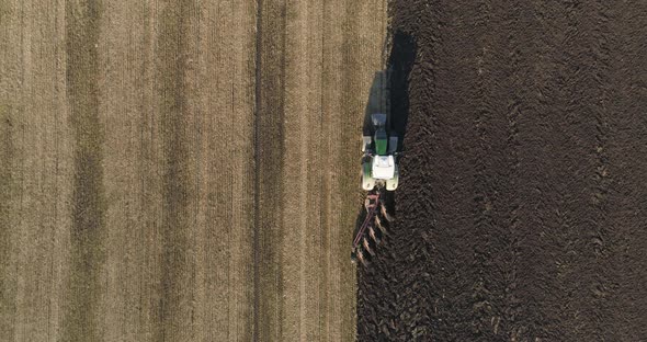 Farm Tractor Plowing Soil in Field Top View Aerial Shot, Stock Footage