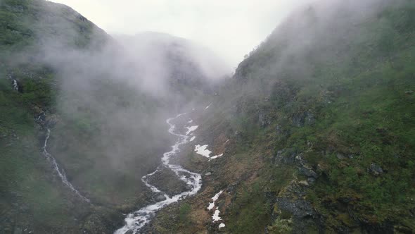Aerial Flying Through Mist In Green Ravine At Hardangervidda National ...