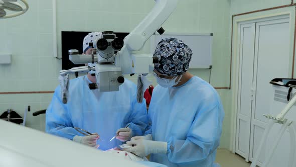 Surgeons Perform a Complex Operation Using a Microscope, Stock Footage