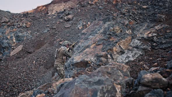 Armed Soldier Walking Over Large Rocks in UHD, Stock Footage | VideoHive