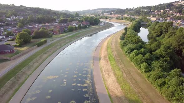 Aerial fly over of beautiful River Exe at golden hour in Exeter, Devon ...