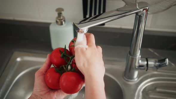 Washing Tomatoes with Tap Water in the Kitchen at Home Preparing ...