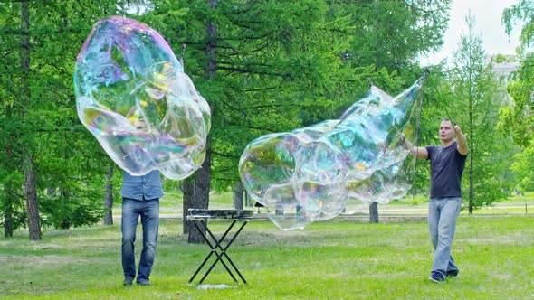 Performers Creating Huge Bubbles in Park, Stock Footage | VideoHive