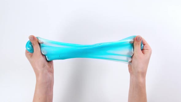 Playing with slime, stretching the gooey substance for fun and stress ...
