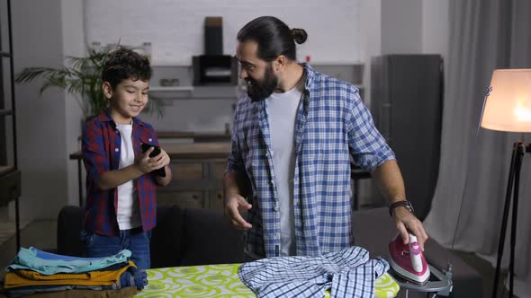 Single Handsome Father Ironing Clothes at Home, Stock Footage | VideoHive
