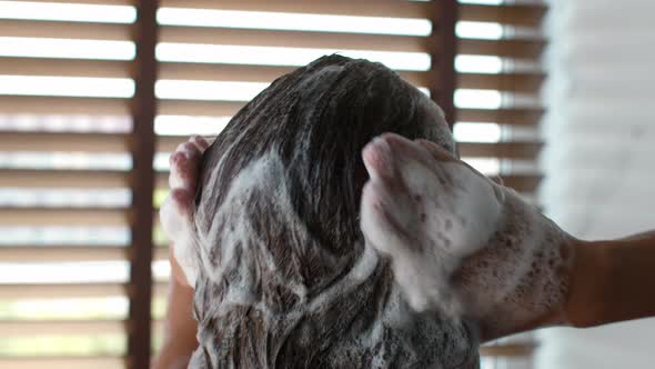 Back View Of Female Washing Hair Using Shampoo In Bathroom, Stock Footage