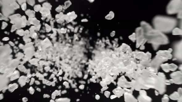 Super Slow Motion Detail Shot of Salt Falling on Black Background at ...
