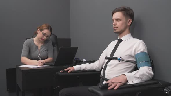 Female Polygraph Expert Examining Young Bearded Man, Stock Footage