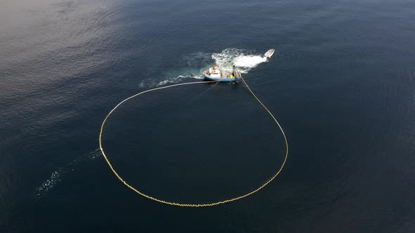 Aerial View of Fishing Ship and Net in Circle Shape, Collecting Fish ...