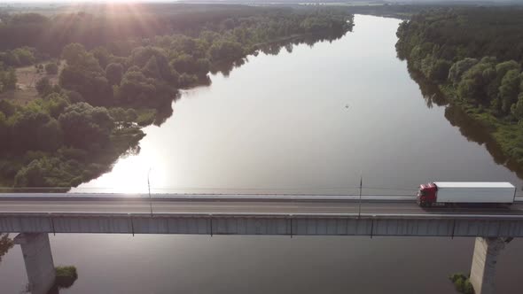 Semi Truck with Cargo Trailer Passing Highway Bridge over the river, in ...
