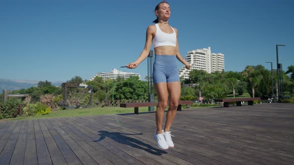 Woman Jumps with Two Skipping Ropes and Does Exercises on Beach, Stock ...