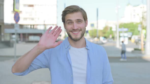 Welcoming Man Waving Hand for Hello Outdoor, Stock Footage | VideoHive