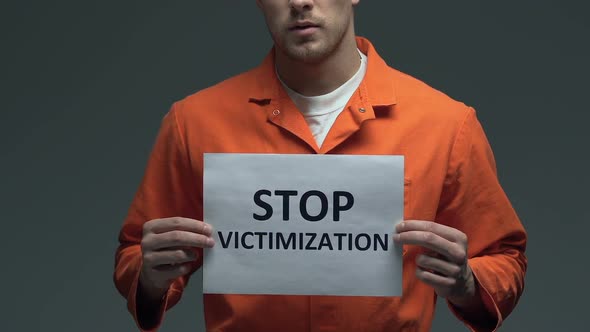Stop Victimization Phrase on Cardboard in Hands of Caucasian Prisoner ...