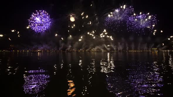 Yellow and Blue Fireworks Burst in Air Over Night City, Stock Footage