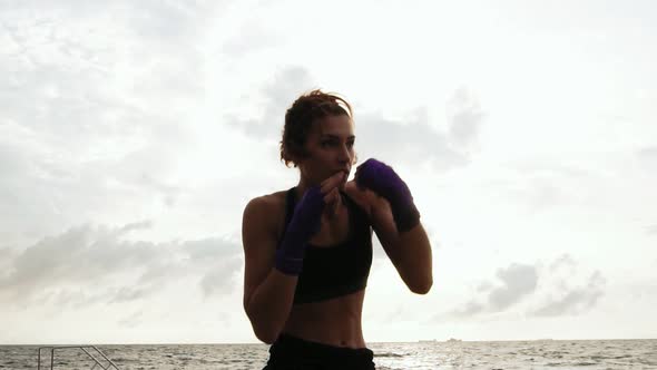 Athletic Young Woman Shadow Boxing By the Sea Against the Sun, Stock ...