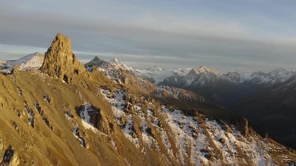 Aerial shot descending parallel to mountain ridge. Alpine landscape ...