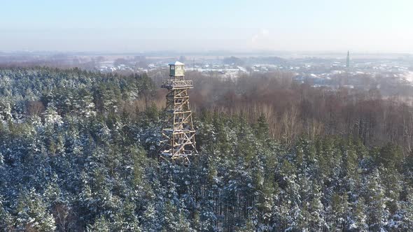 Aerial view of Forest rangers tower in a snowy forest by andrisbarbans