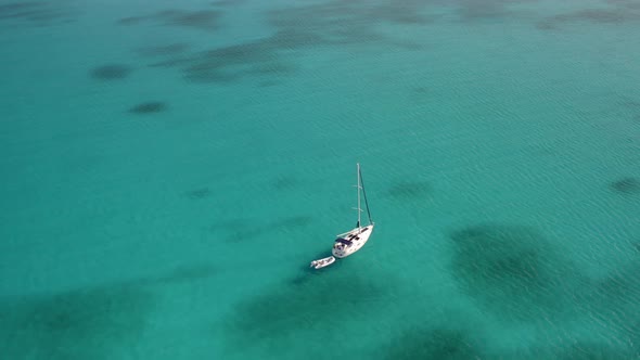 White Boat Cruising At The Blue Water Of Bahamas Beach. aerial, orbit ...