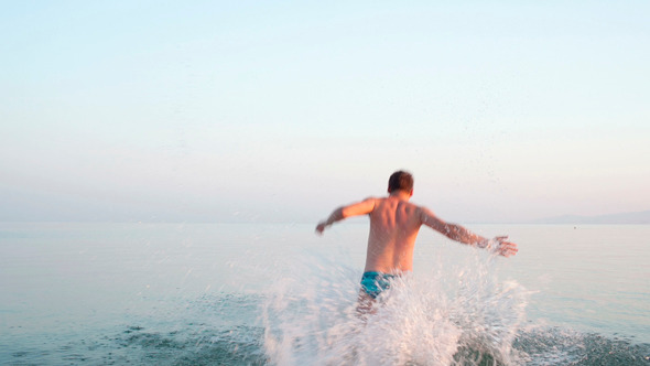 Man Rushing Into The Sea, Stock Footage | VideoHive