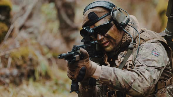 British Army Ranger on the War Zone Peace Mission Aiming an Automatic ...