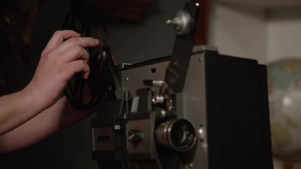 Person putting wheel on old projector, Stock Footage | VideoHive