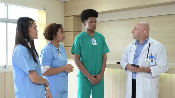 A medical professor gives advice on patient examinations to medical ...