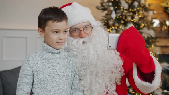 Santa and Little Boy Making Video Call Online Using Modern Smartphone ...