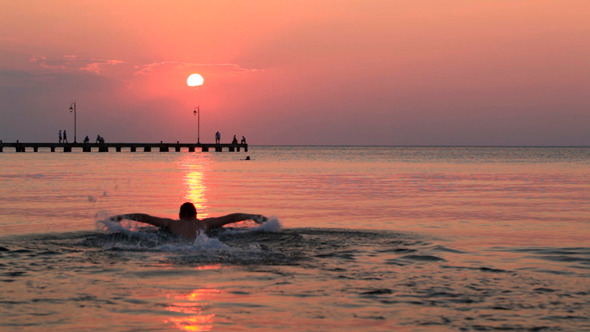 Man Swimming in the Sea at Sunset, Stock Footage | VideoHive