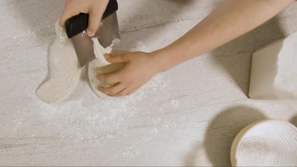 top down shot of Young Male Chef Forming Sourdough Dough on a kitchen ...